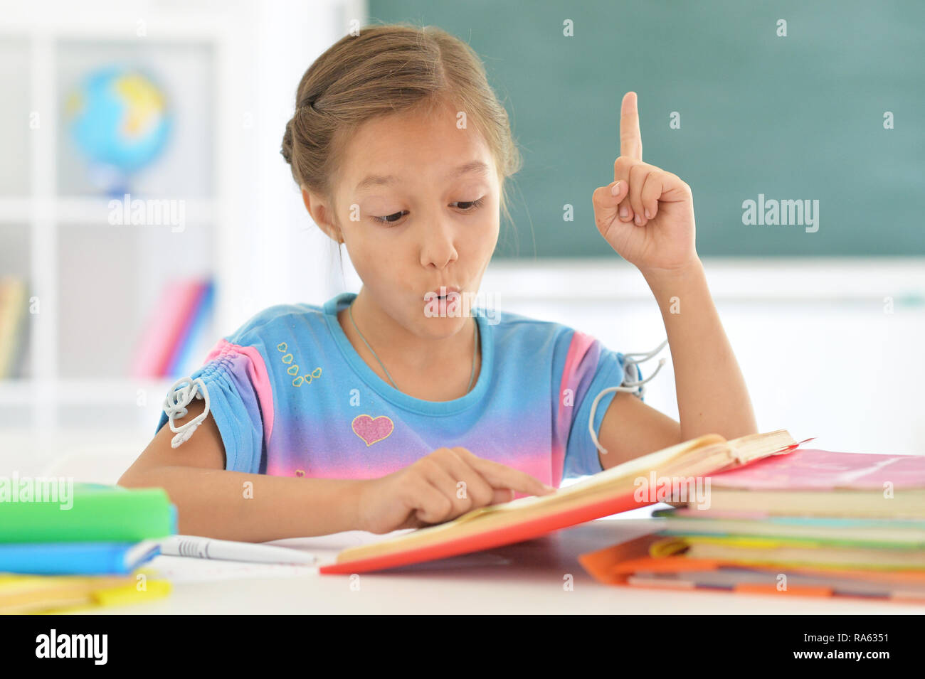 Portrait of cute little girl doing homework Stock Photo - Alamy