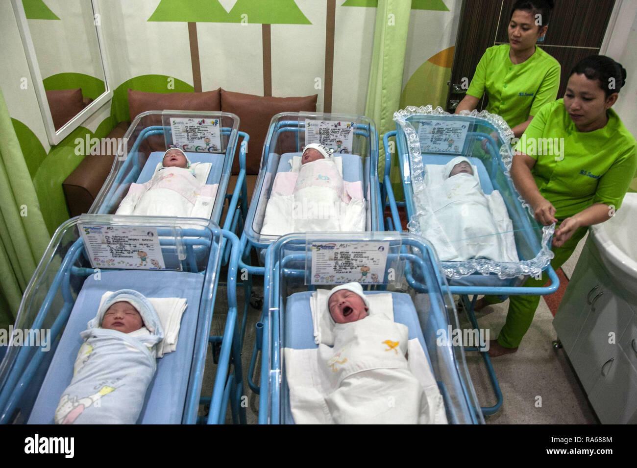 Medan, North Sumatra, Indonesia. 1st Jan, 2019. A nurse with a babies ...