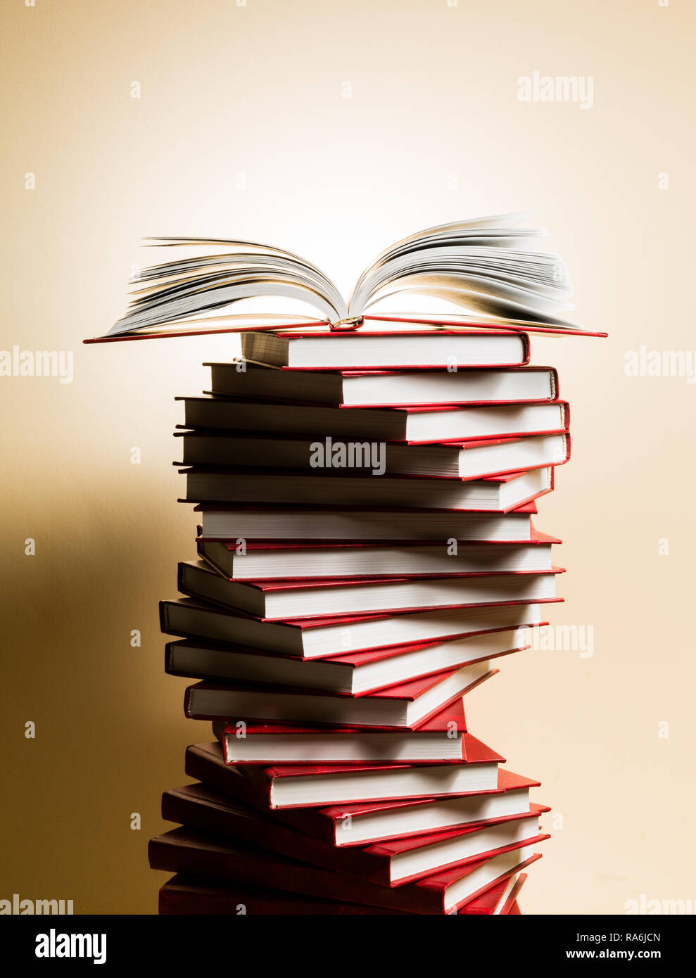 A spiral of stacks of books in the form of DNA and an open textbook at ...