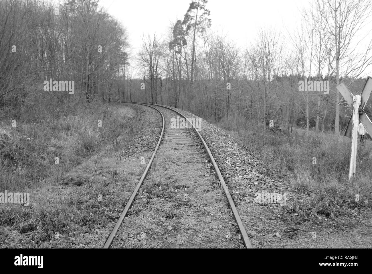 Railway tracks run away from the viewer in a curve Stock Photo - Alamy