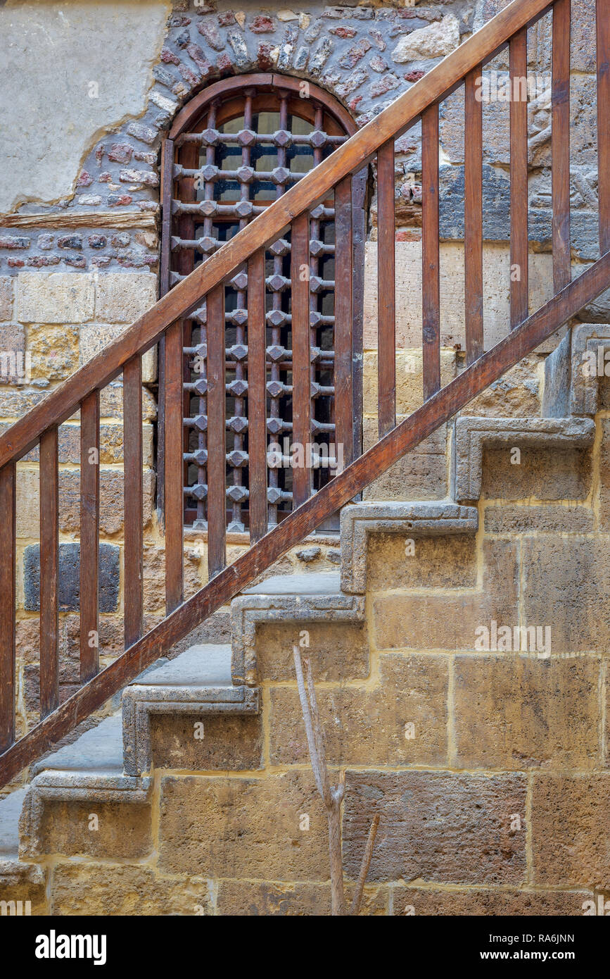Wooden window and staircase with wooden balustrade leading to historic ...