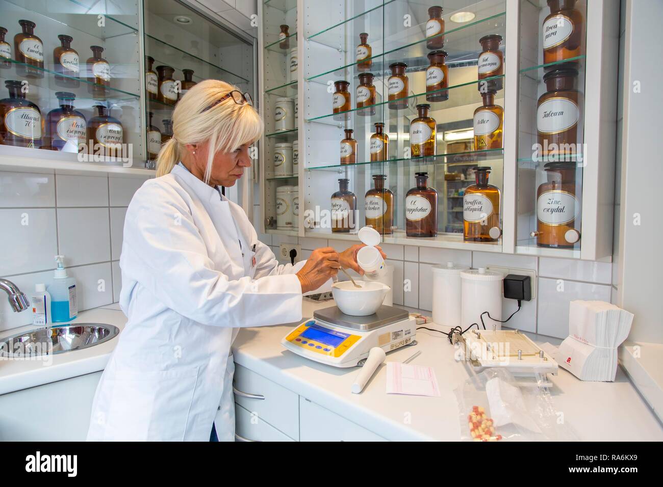 Pharmacy, pharmacist produces an individual medication, in the ...