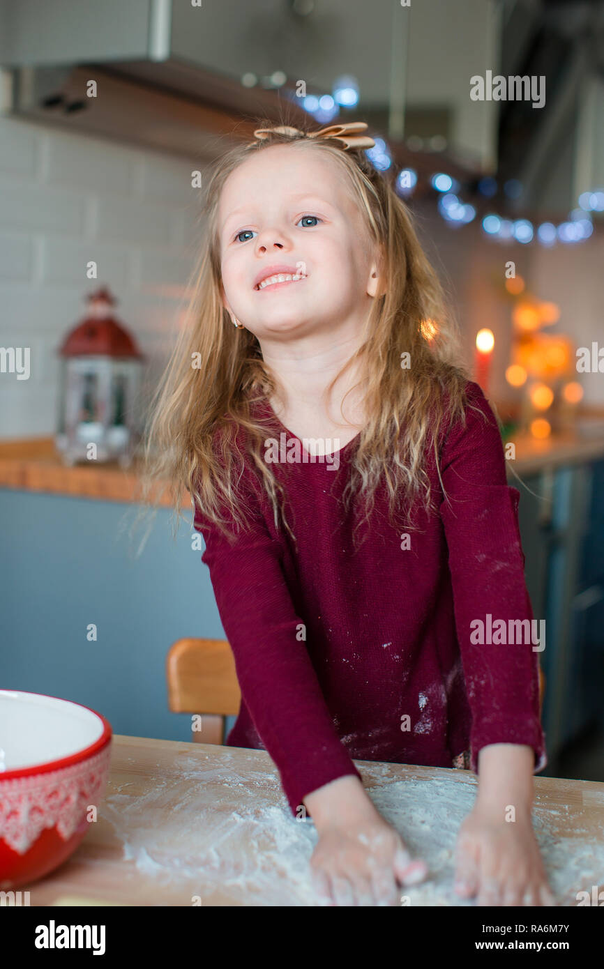 Adorable little girl baking Christmas gingerbread cookies Stock Photo ...