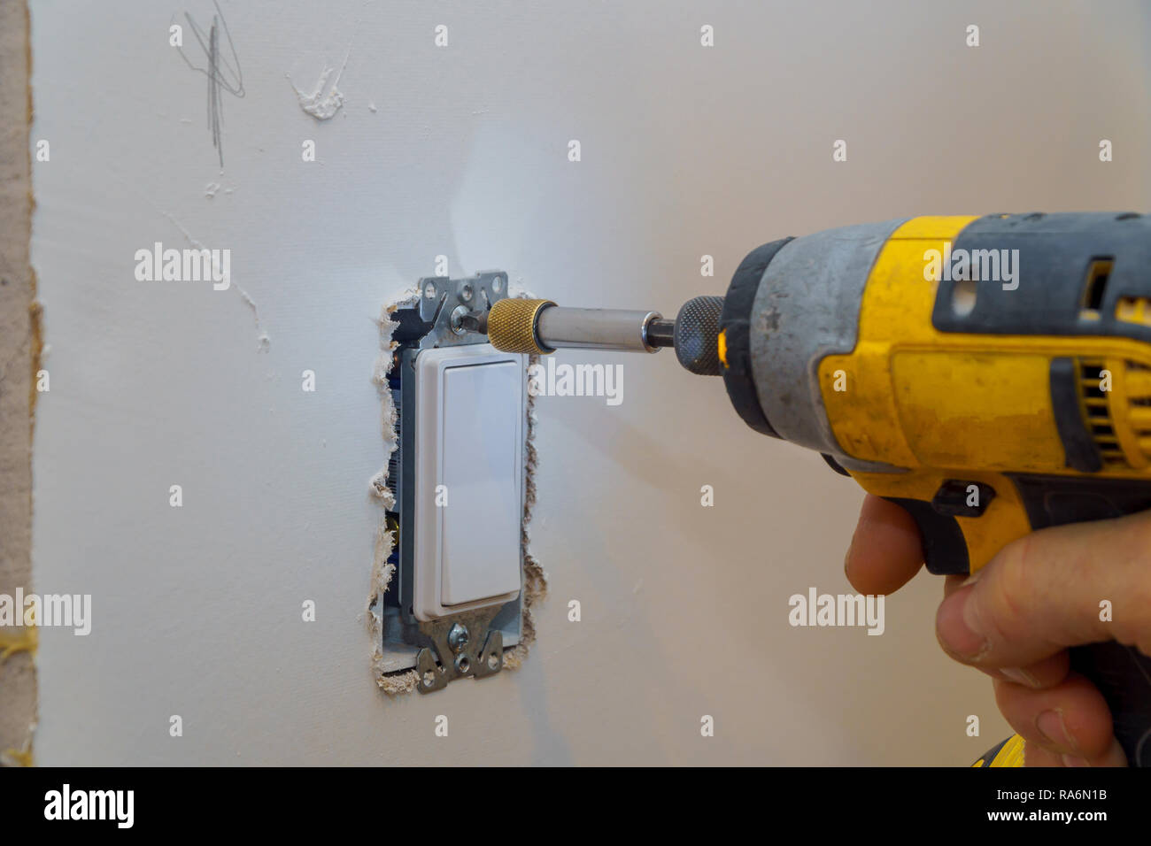 Wall socket installation a screw on an electrical outlet Stock Photo ...