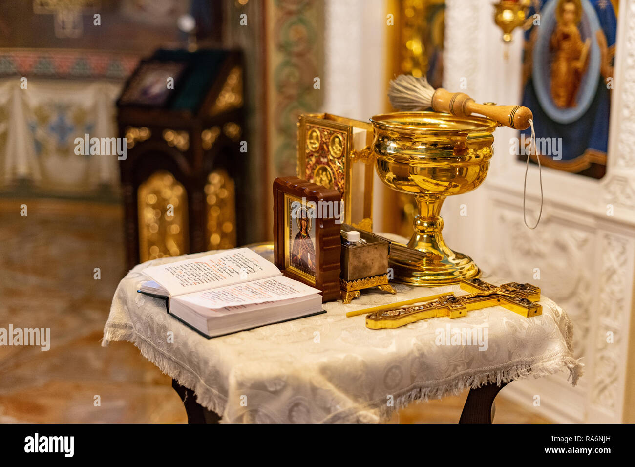 Golden orthodox utensils with holy bible and different stuff on temple ...