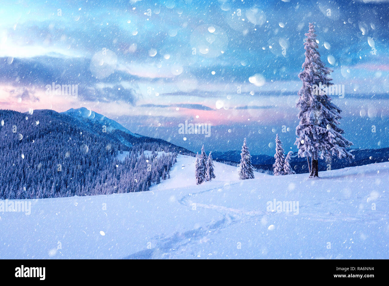 Fantastic orange winter landscape in snowy mountains glowing by sunlight. Dramatic wintry scene ...