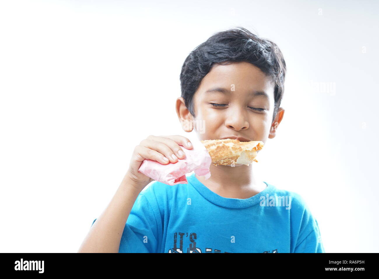 Young Boy eating kebab or shawarma Stock Photo - Alamy