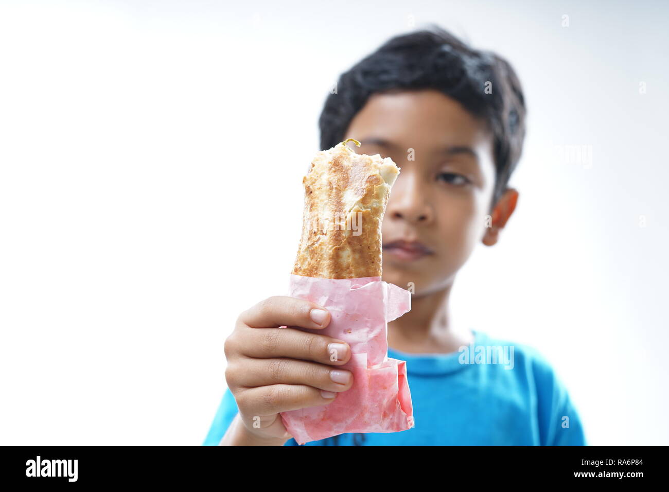Young Boy eating kebab or shawarma Stock Photo - Alamy