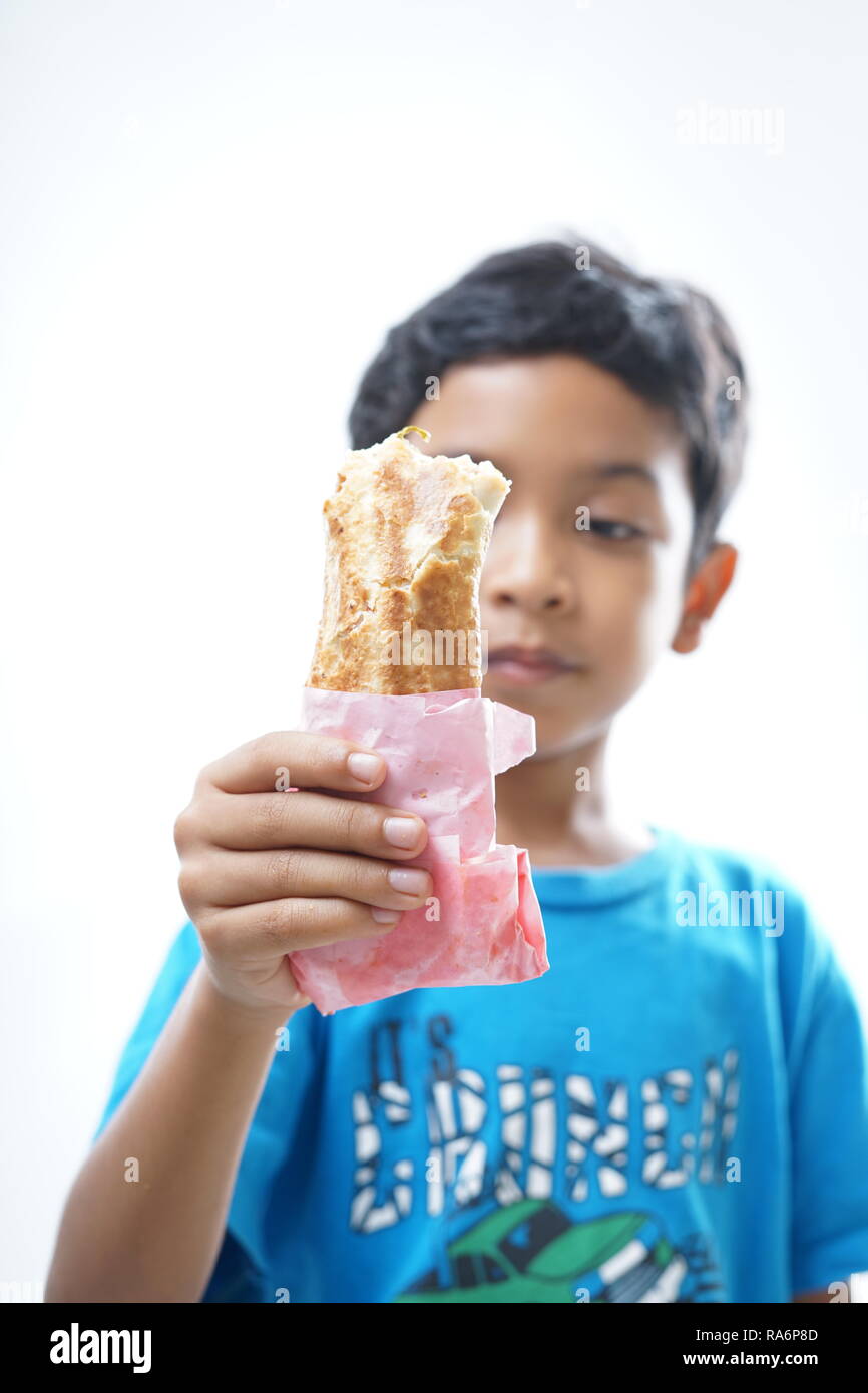 Young Boy eating kebab or shawarma Stock Photo - Alamy