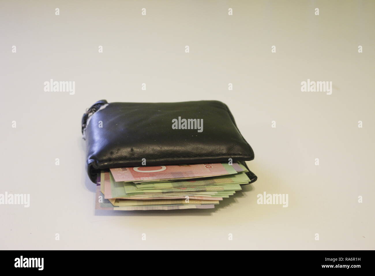 Male wallet with Canadian dollars, isolated on white Stock Photo - Alamy