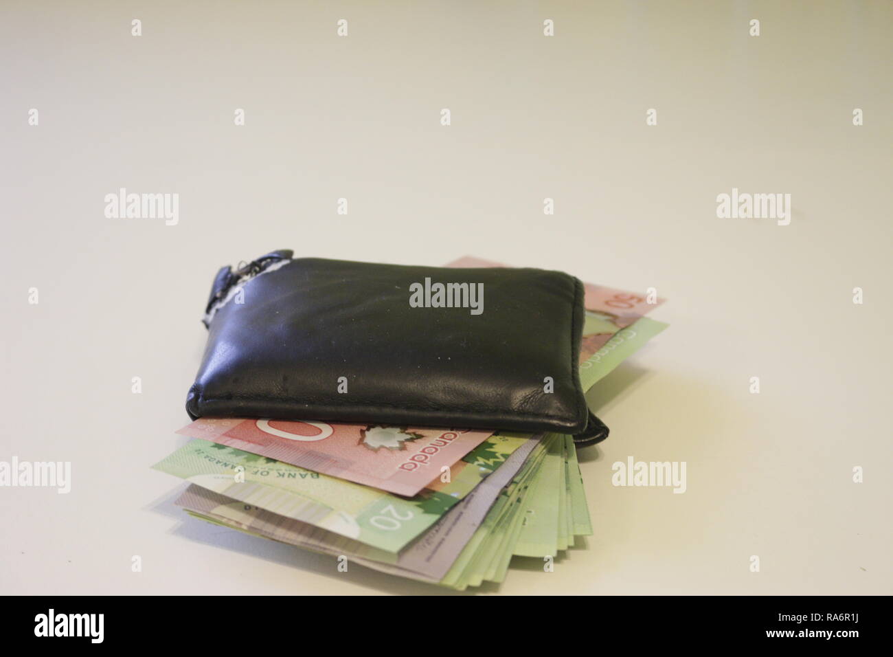 Male wallet with Canadian dollars, isolated on white Stock Photo - Alamy