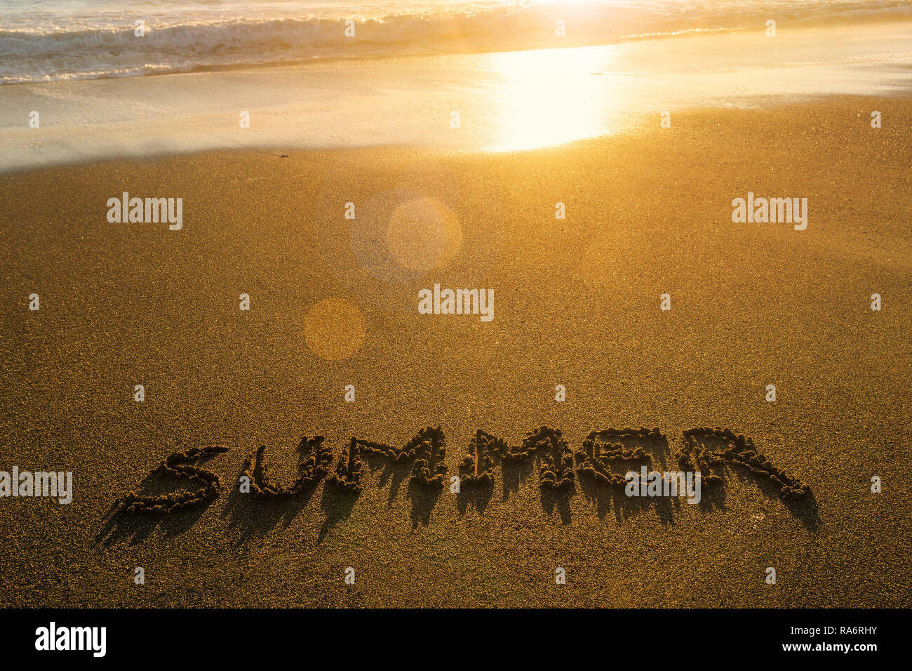 Summer in letters written in the sand at sunset, holidays by the sea ...
