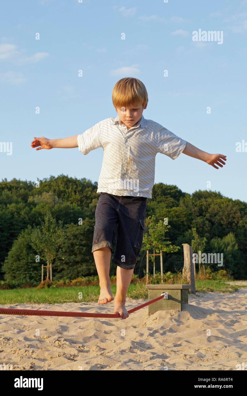 Young boy balancing on a rope in Egestorf Barefoot Park, Egestorf ...