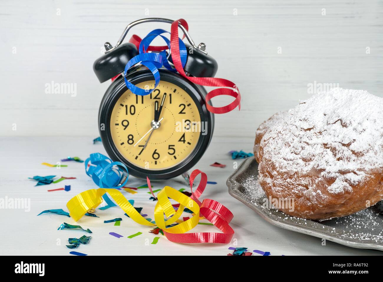 confetti and ribbon on retro clock with midnight time and New Years ...
