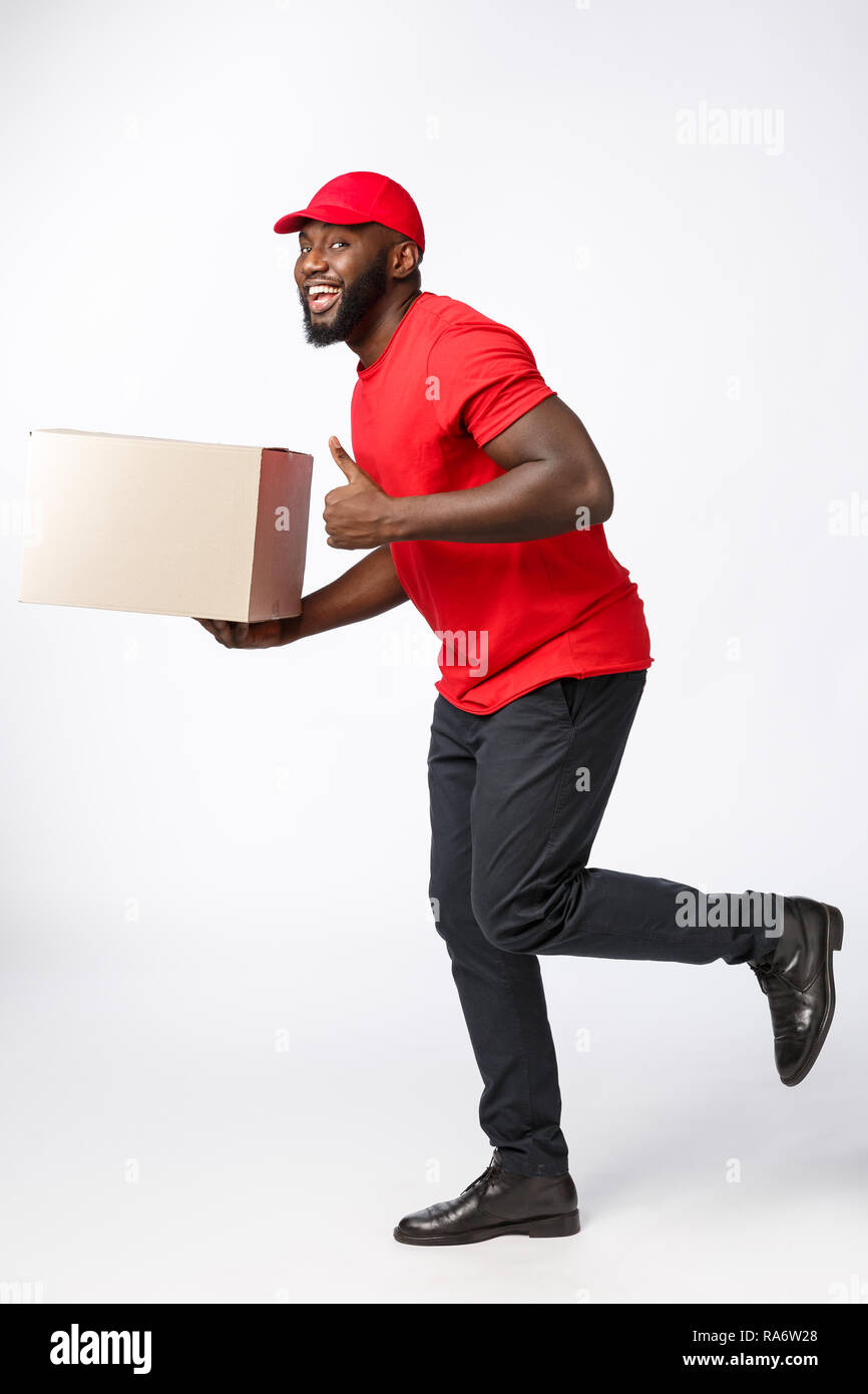 Portrait of Happy African American delivery man in red cloth walking to ...