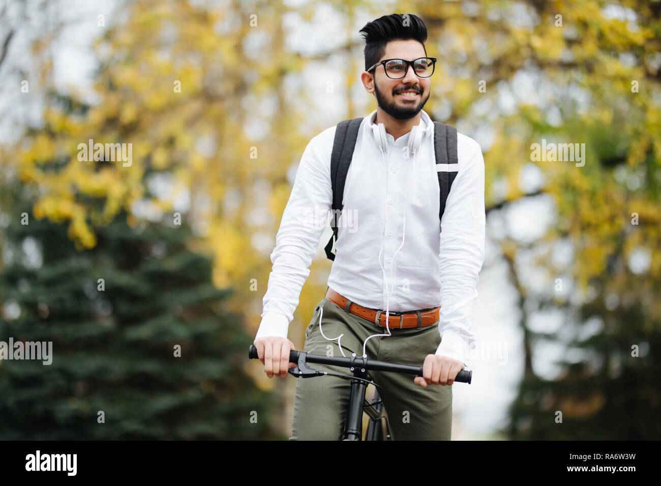 Indian man riding bicycle to work in town street Stock Photo - Alamy