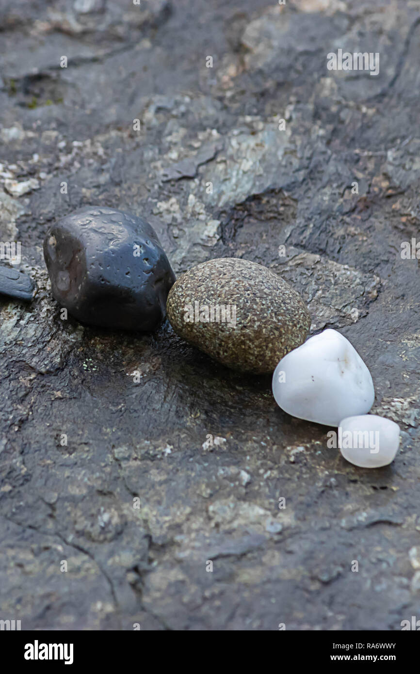 pretty rocks layed out on a stone slab Stock Photo - Alamy