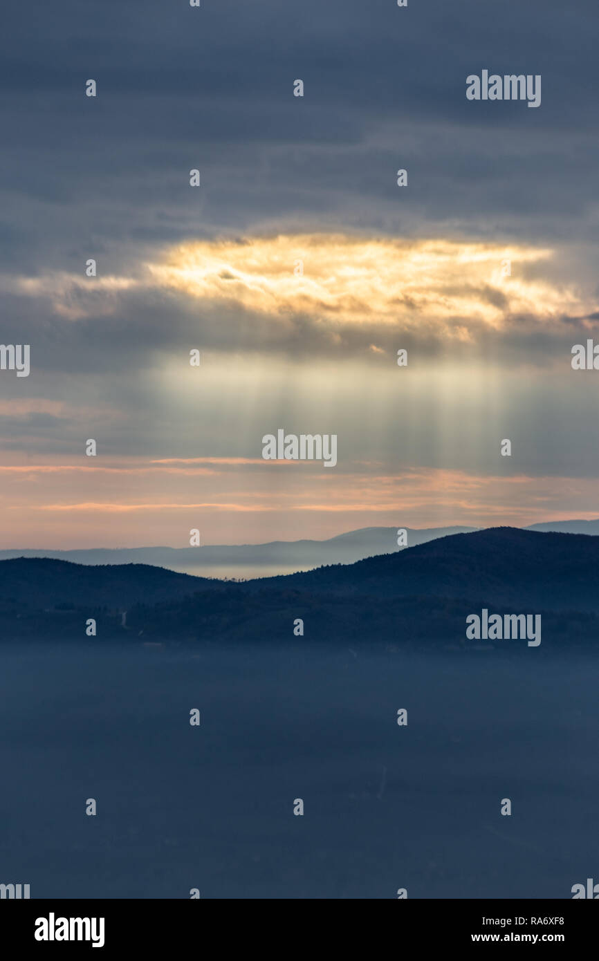 Sunray shines through clouds over the mountains and a sea of fog Stock ...