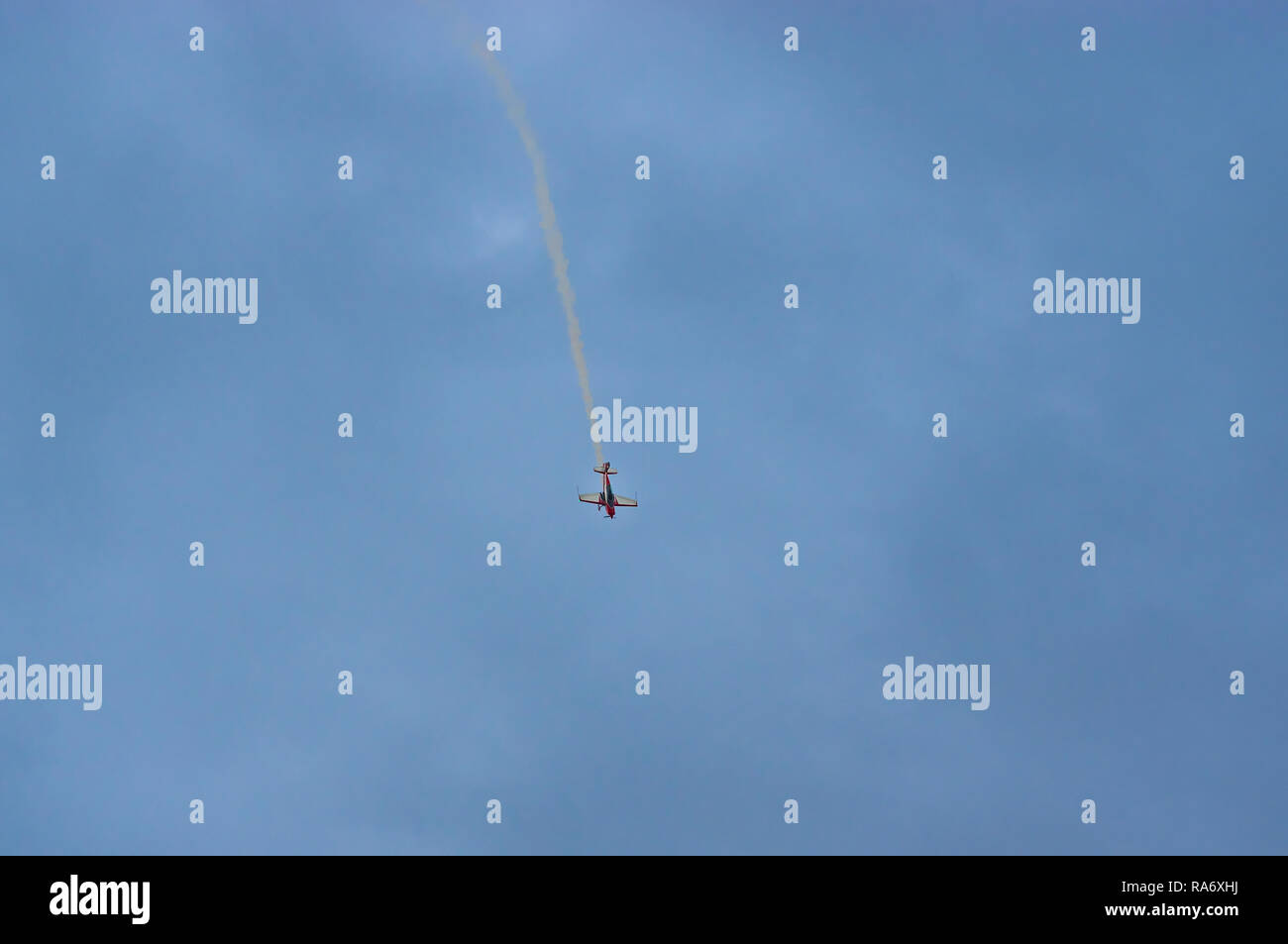 Light training plane doing loop in dark skies Stock Photo - Alamy