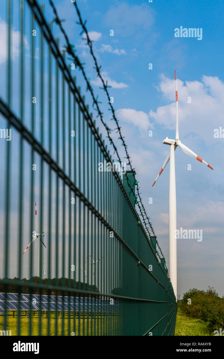 renewable energy concept: photovoltaic panels and wind turbines behind ...