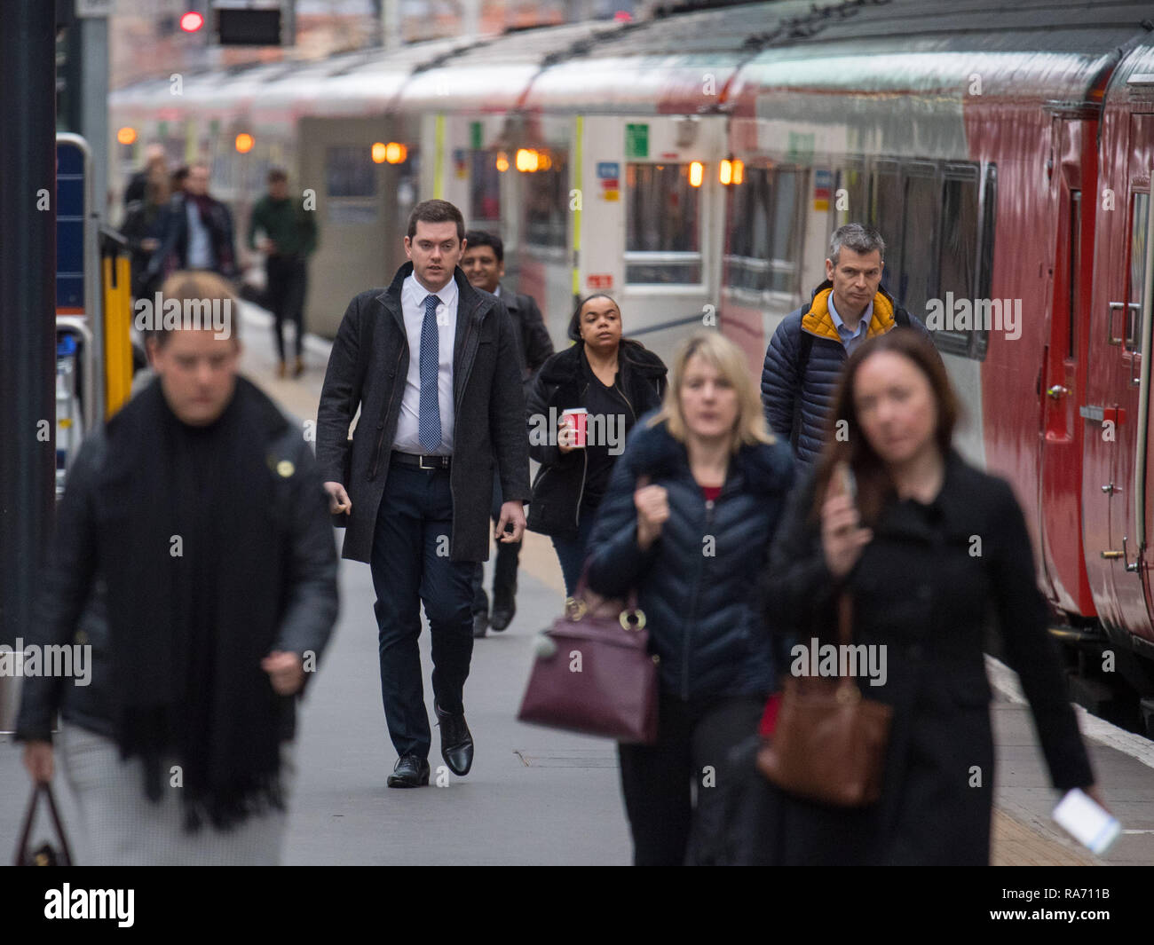Passengers disembark a train at Kings Cross St Pancras station in ...