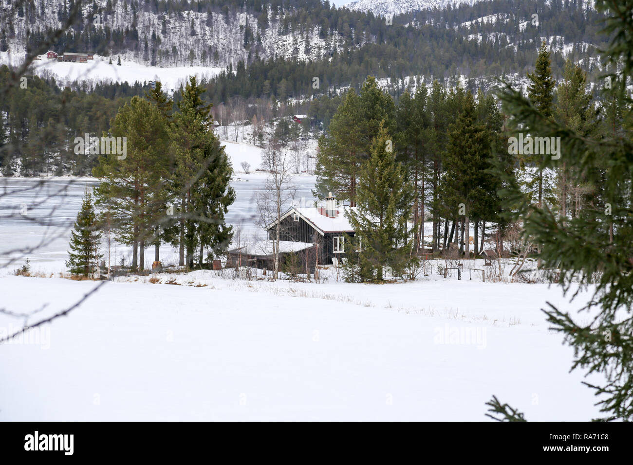 Norwegian cabin in the snow by a lake Stock Photo - Alamy