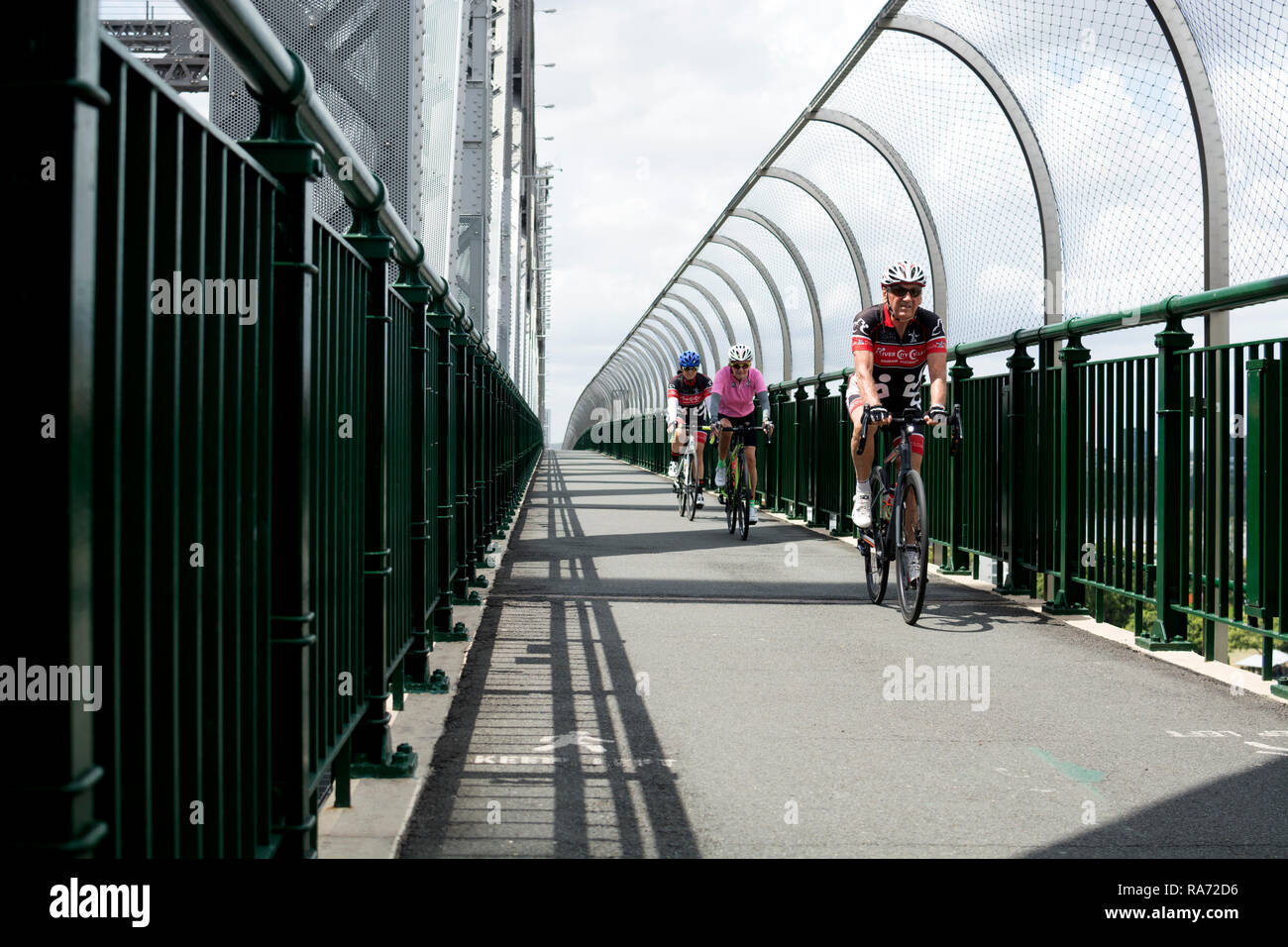 Across bridge three cyclists hi-res stock photography and images - Alamy