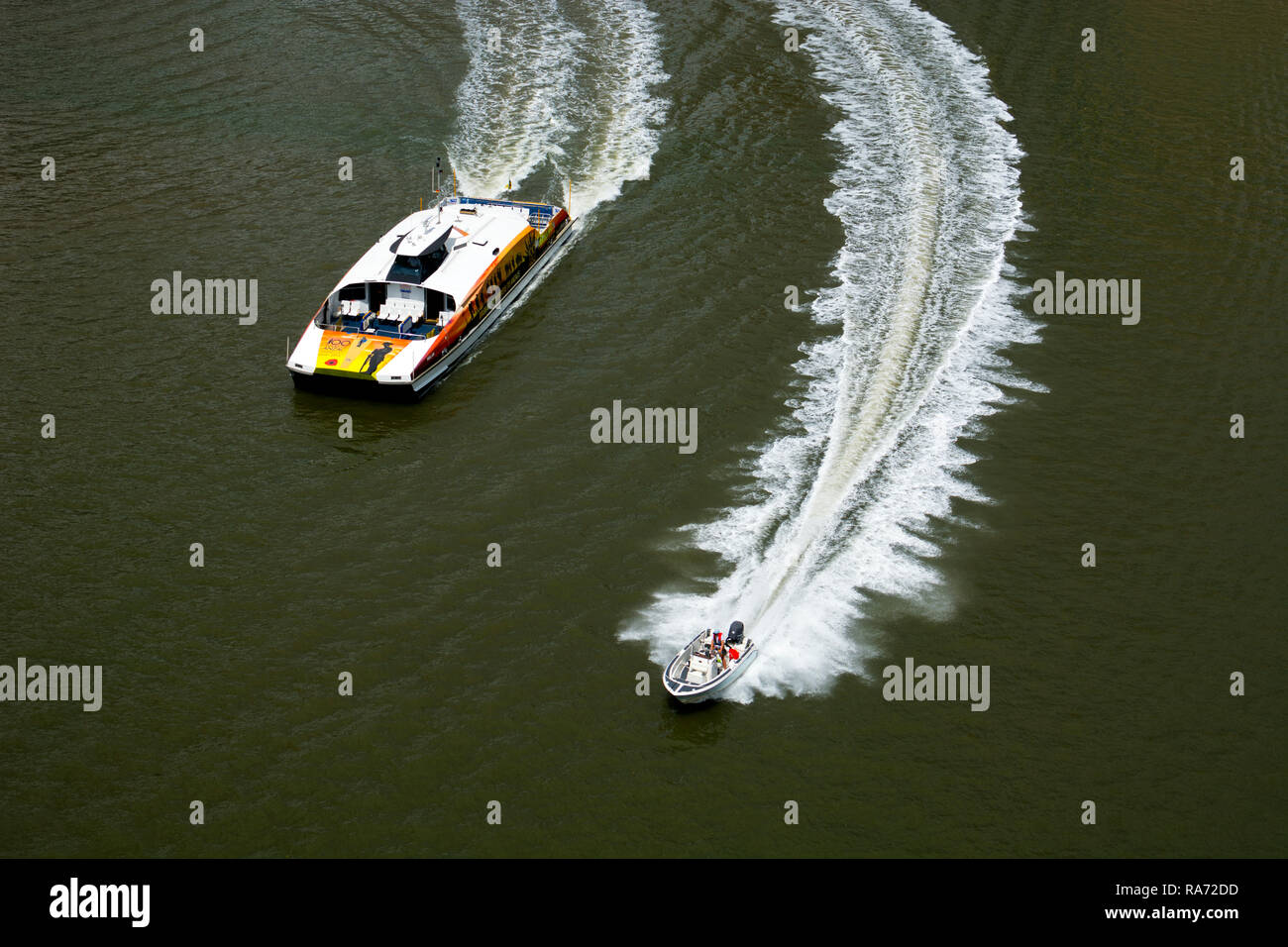 A speedboat and a CityCat ferry on the Brisbane River, Brisbane ...