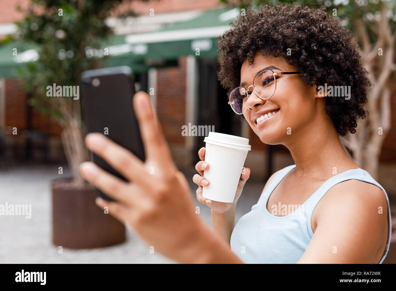 Social media influencer vlogging while drinking coffee to go Stock ...