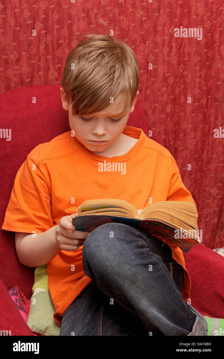 Boy reading a comic book Stock Photo - Alamy