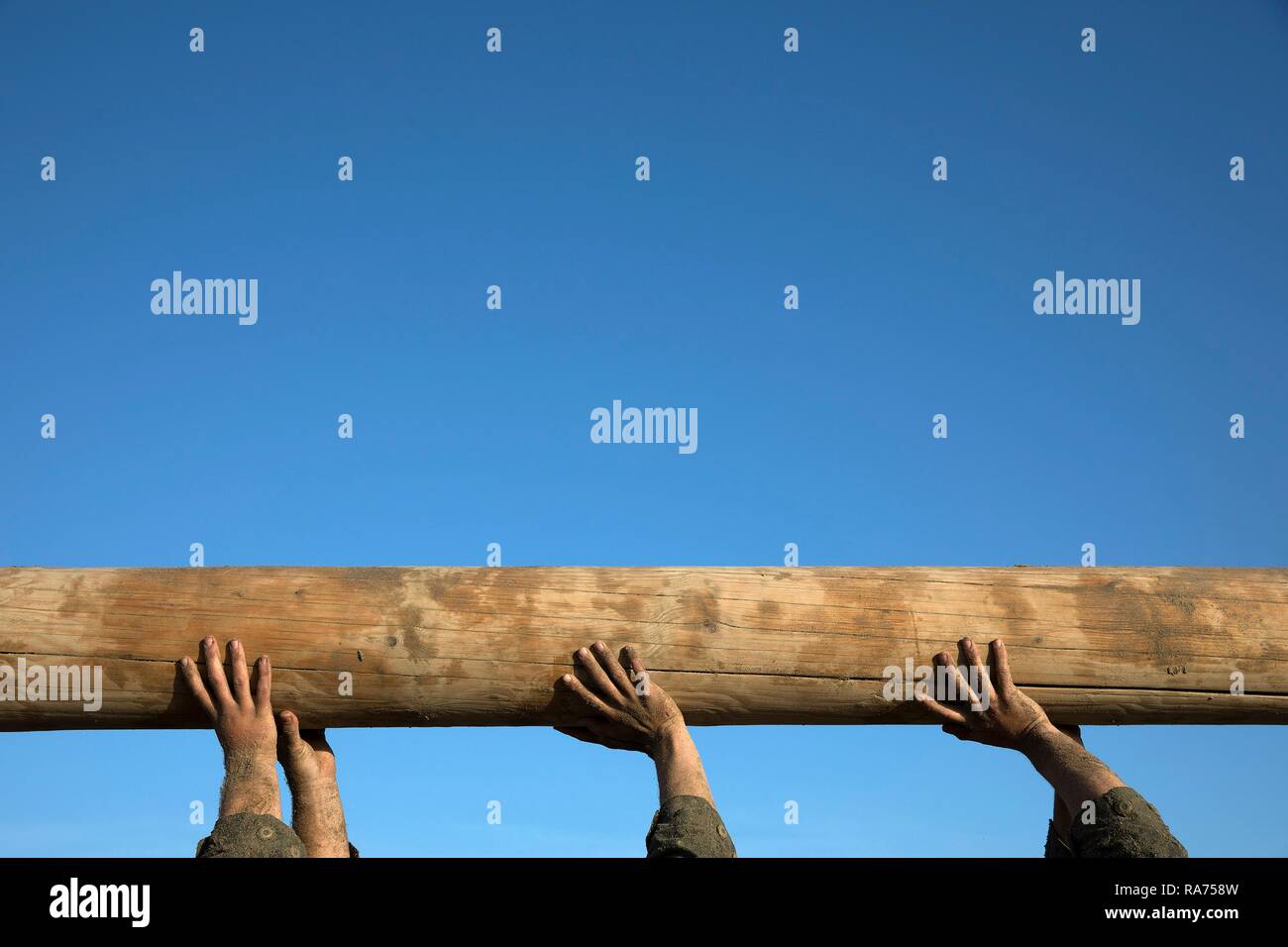 U.S. Navy SEAL candidates team lift a log during Basic Underwater ...