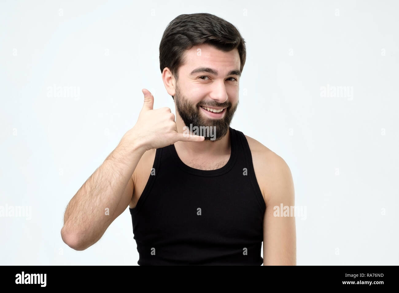 Young handsome man making call me sign Stock Photo - Alamy