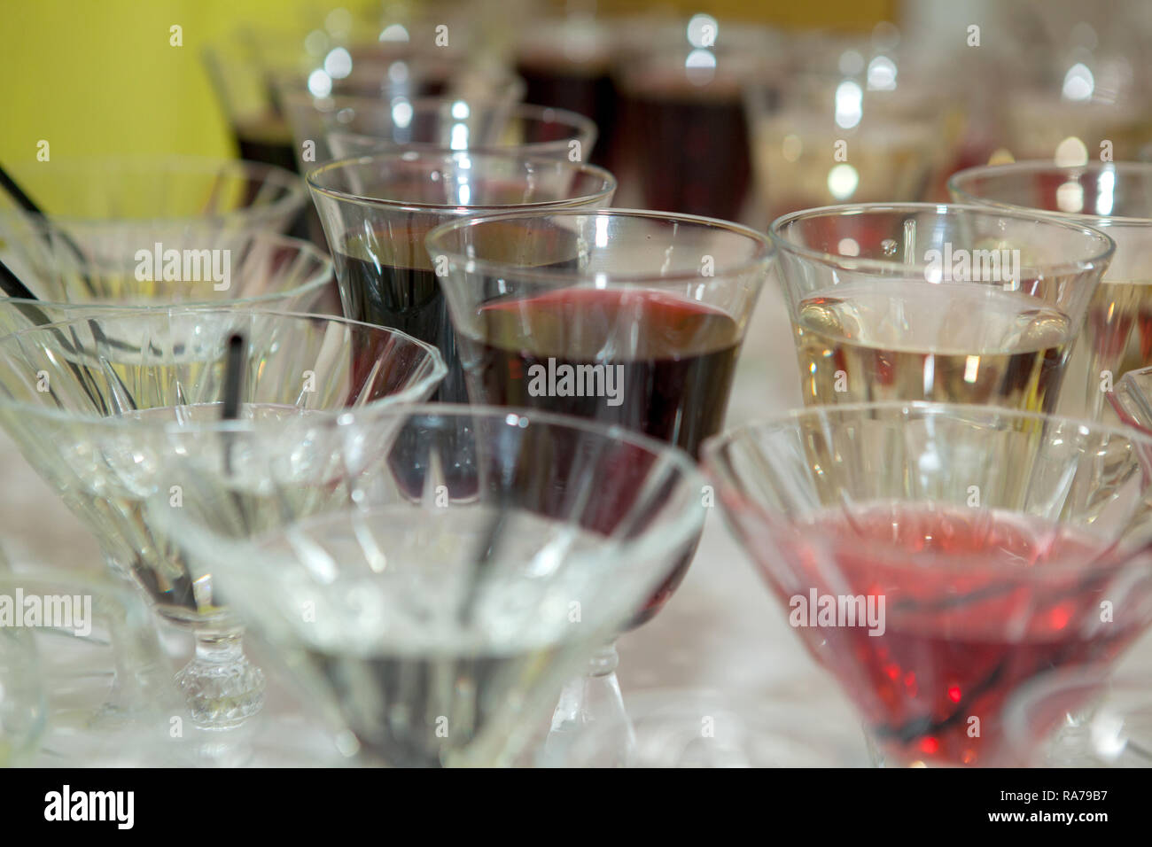 Beautiful row line of different colored alcohol cocktails on a party ...