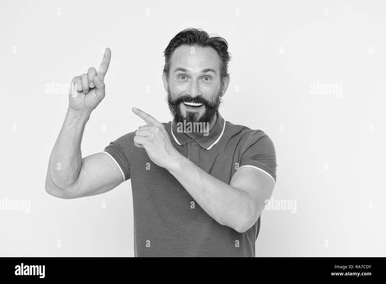 Pointing direction. Man pointing index fingers yellow background. Guy ...