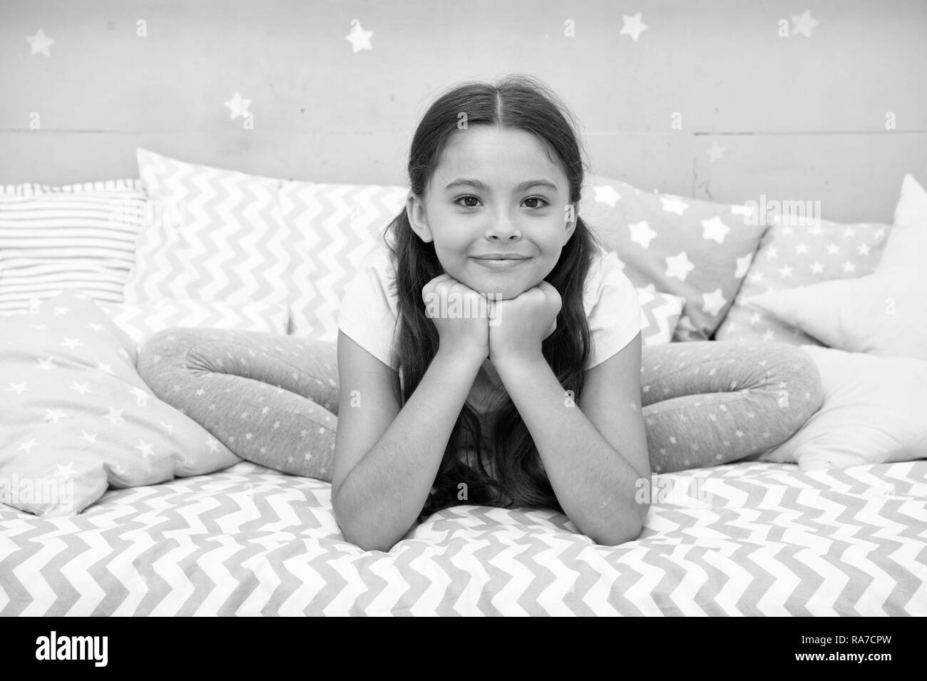 Cute gymnast stretching on bed. Girl child sit bed in her bedroom. Kid ...