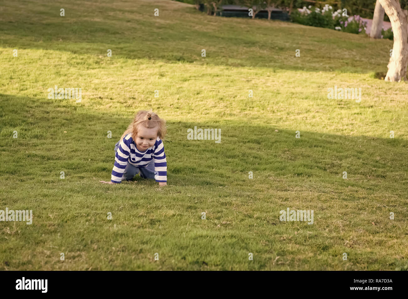 Activity, experience, learning. Boy with blond hair crawl on green ...