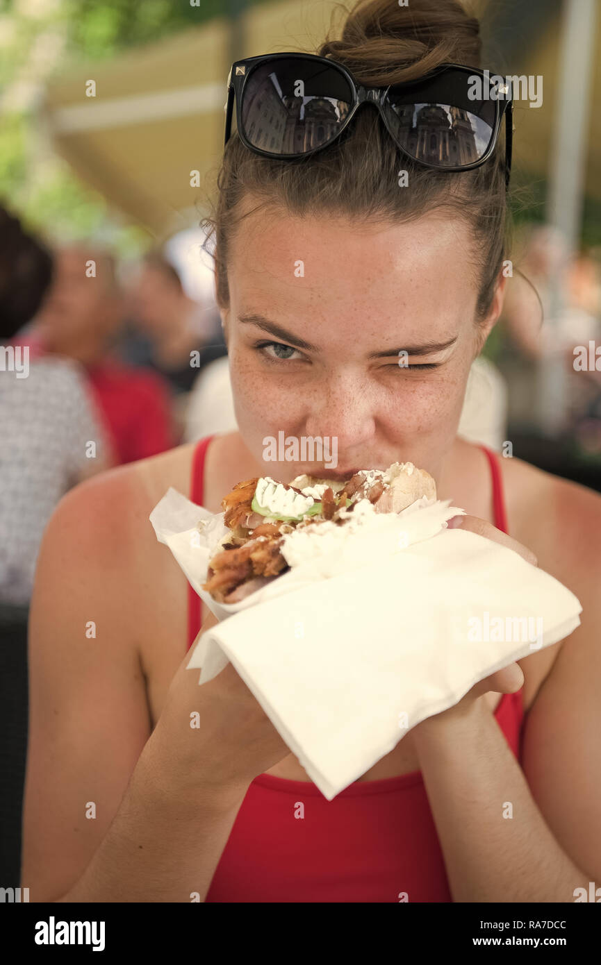 pretty girl or Woman eating sandwich gyros. Girl with pleasure eats ...