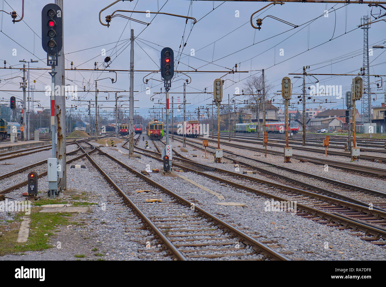 Multiple train tracks leading into station with trafic lights directing ...