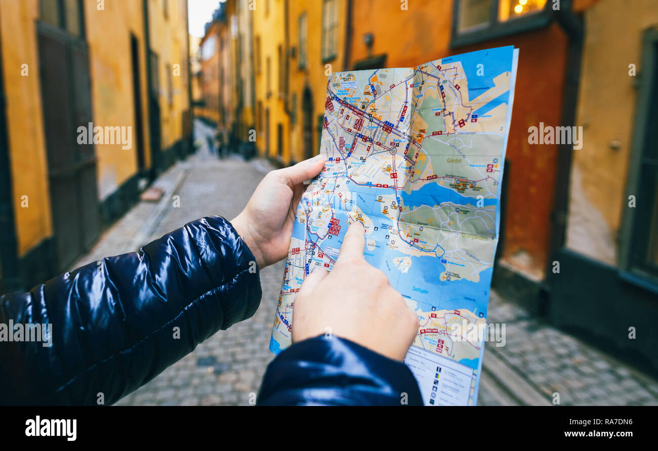 Travel Lifestyle. Woman traveler with map in hand on the streets of ...