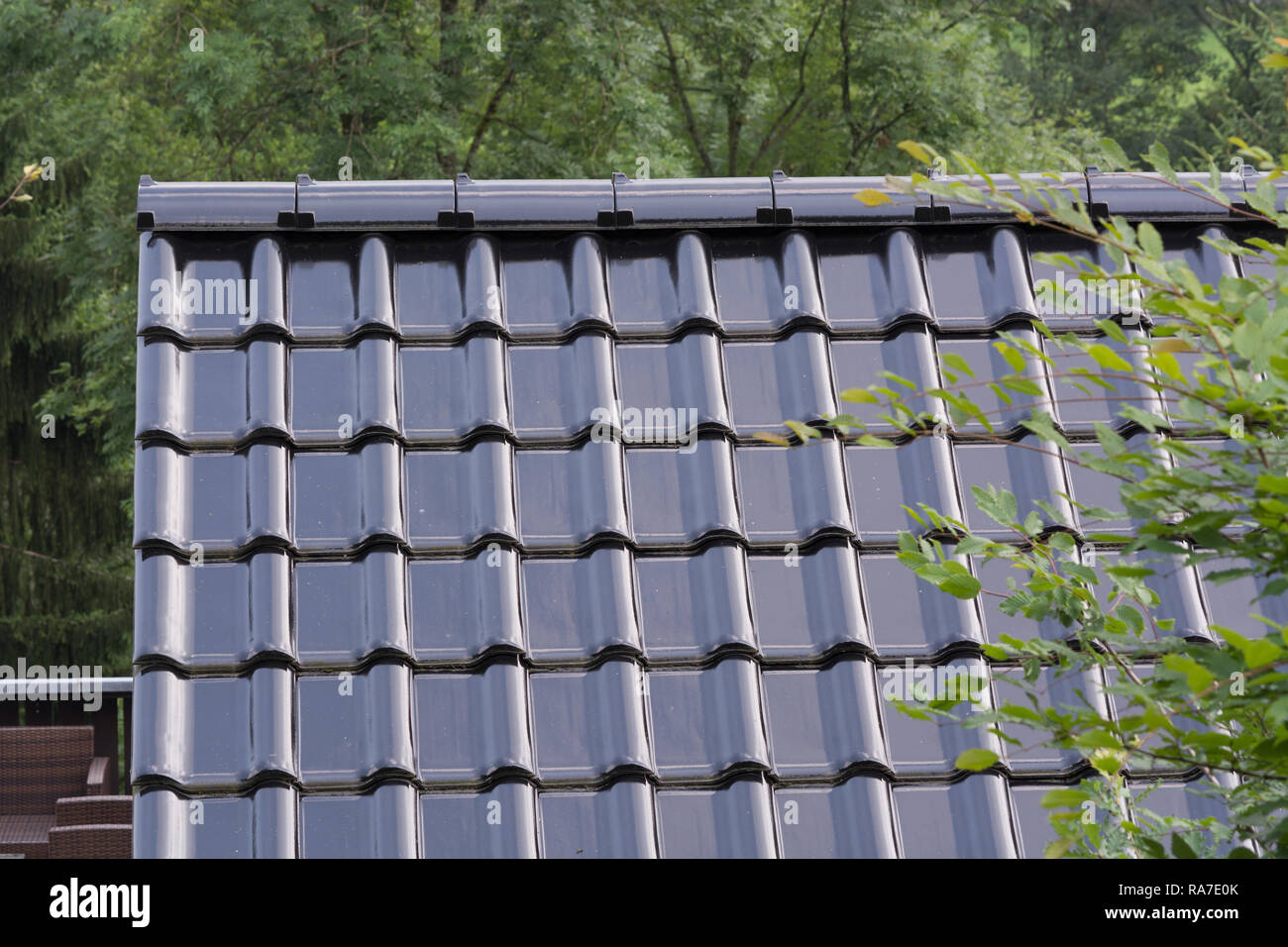 Modern roof with PVC coated black roof tiles with brick effect Stock ...