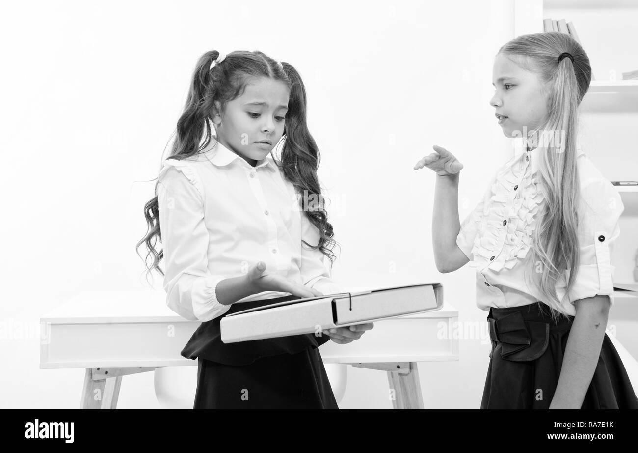 Little girls discuss problem on school day. little girls work on ...