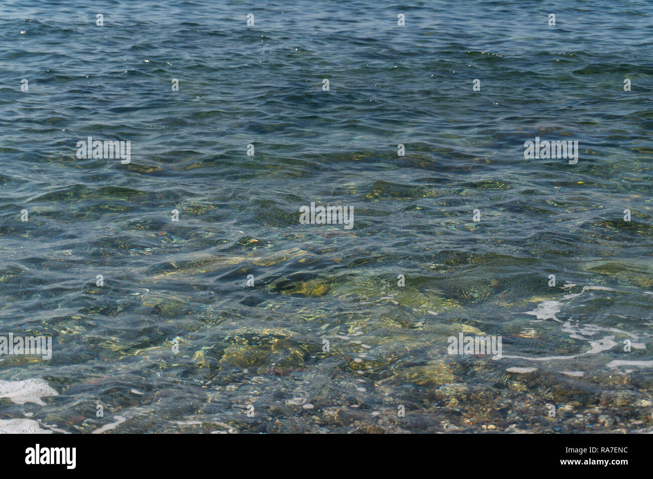 Clear water and colorful pebbles on the bottom of the sea Stock Photo ...