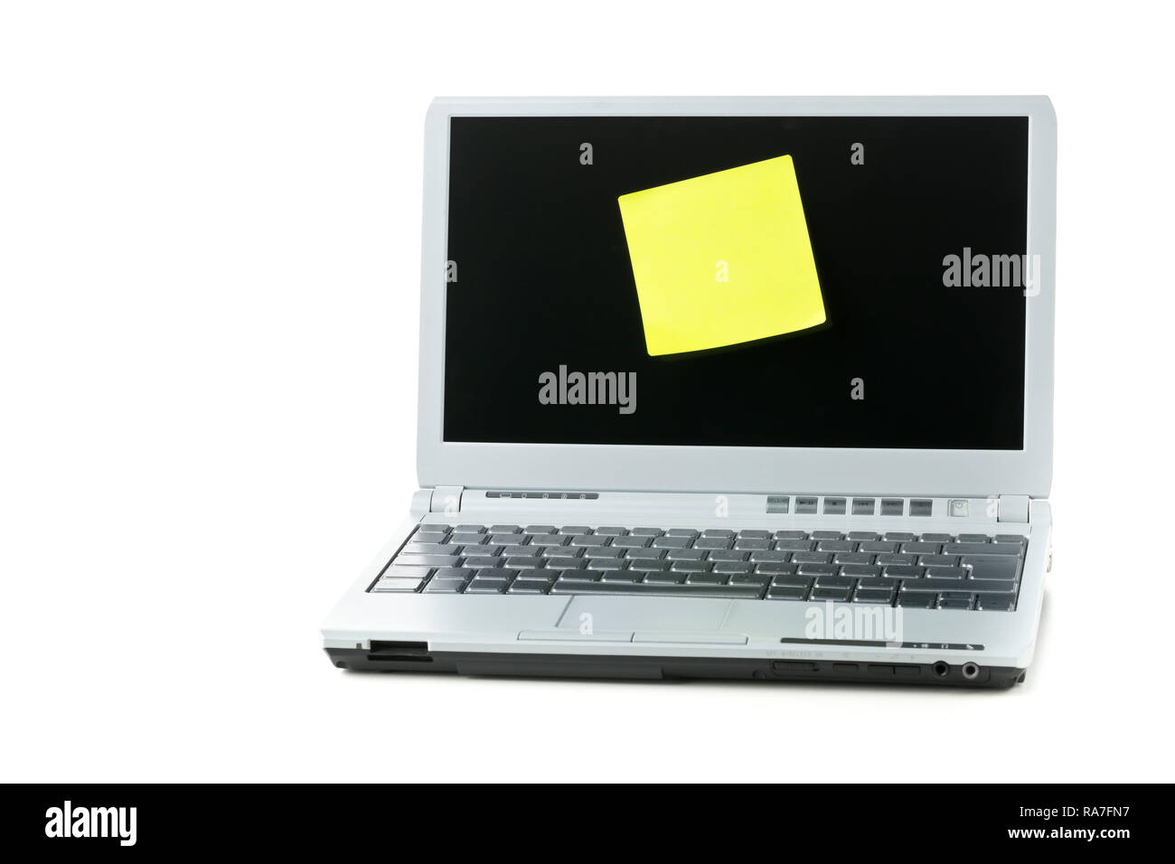 Empty yellow sticky paper note on laptop with copy space over white ...