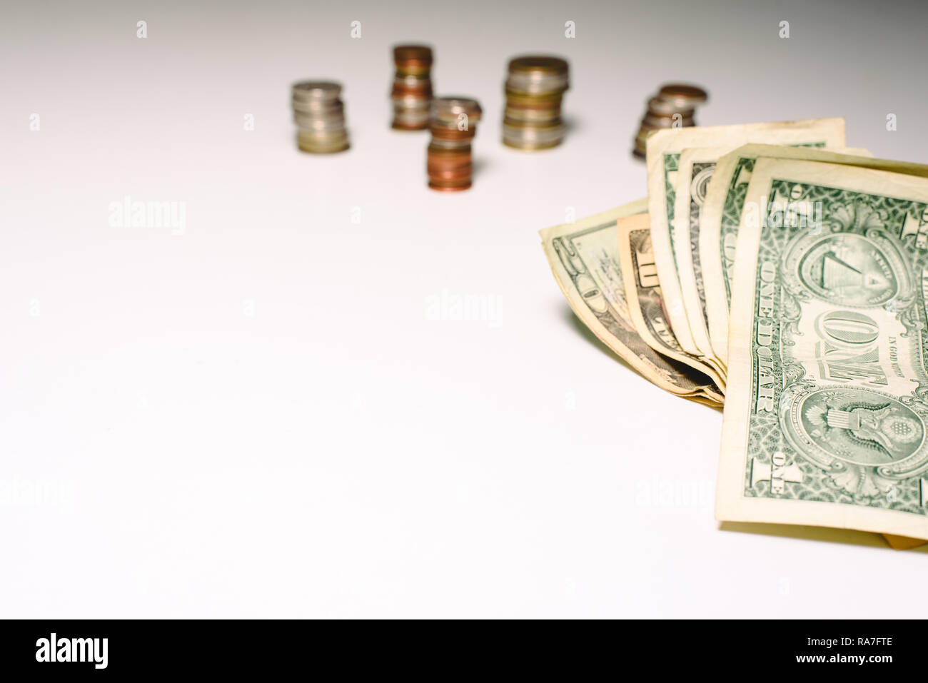 Coins and dollar bills isolated on white background with copy space ...