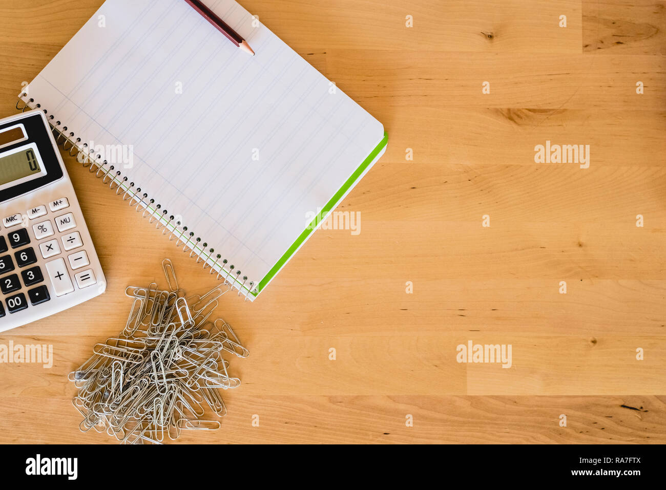 Calculator, paper clips and pencil for finance Stock Photo - Alamy
