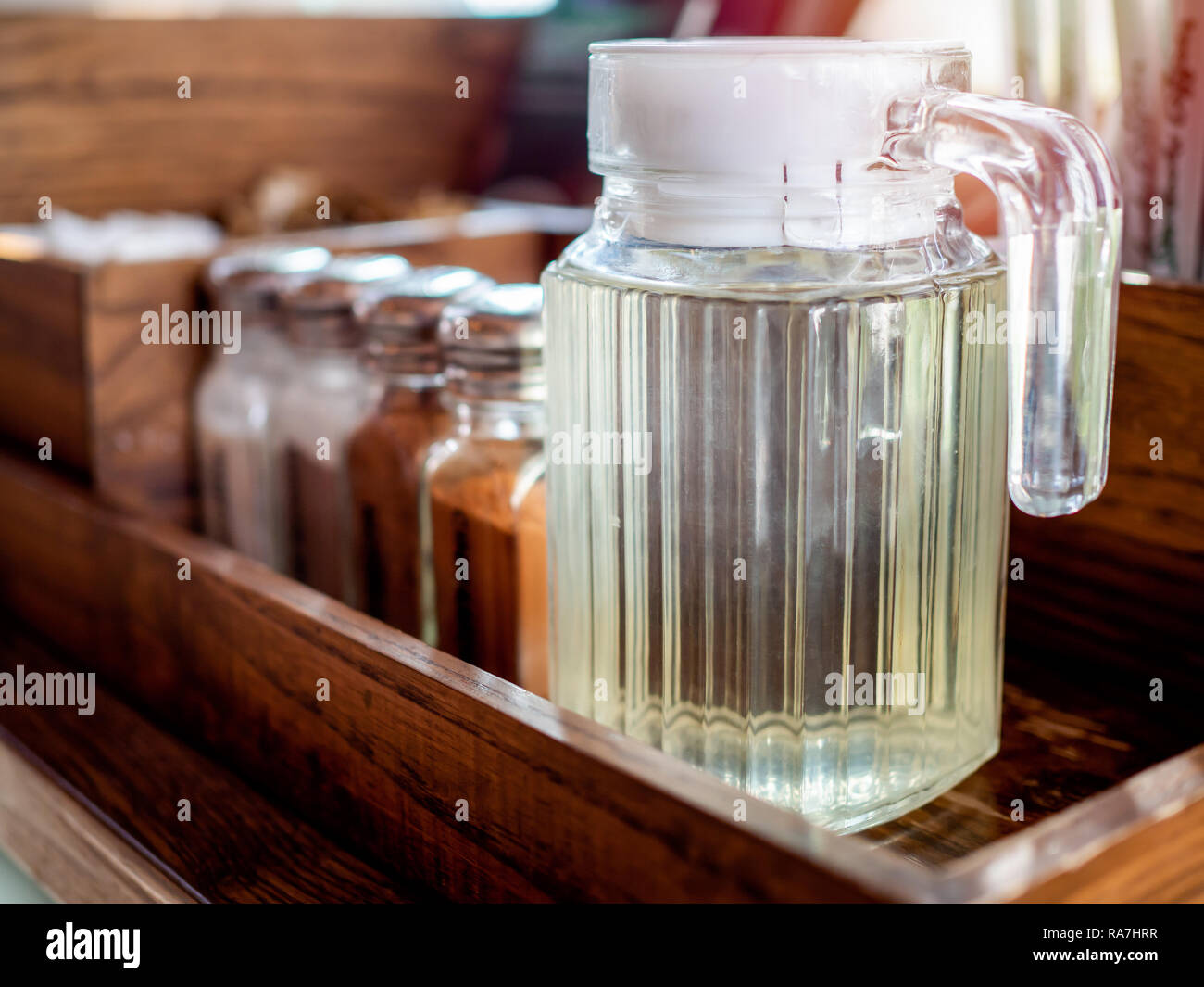 Syrup in the glass jug on wooden shelf in coffee shop Stock Photo - Alamy
