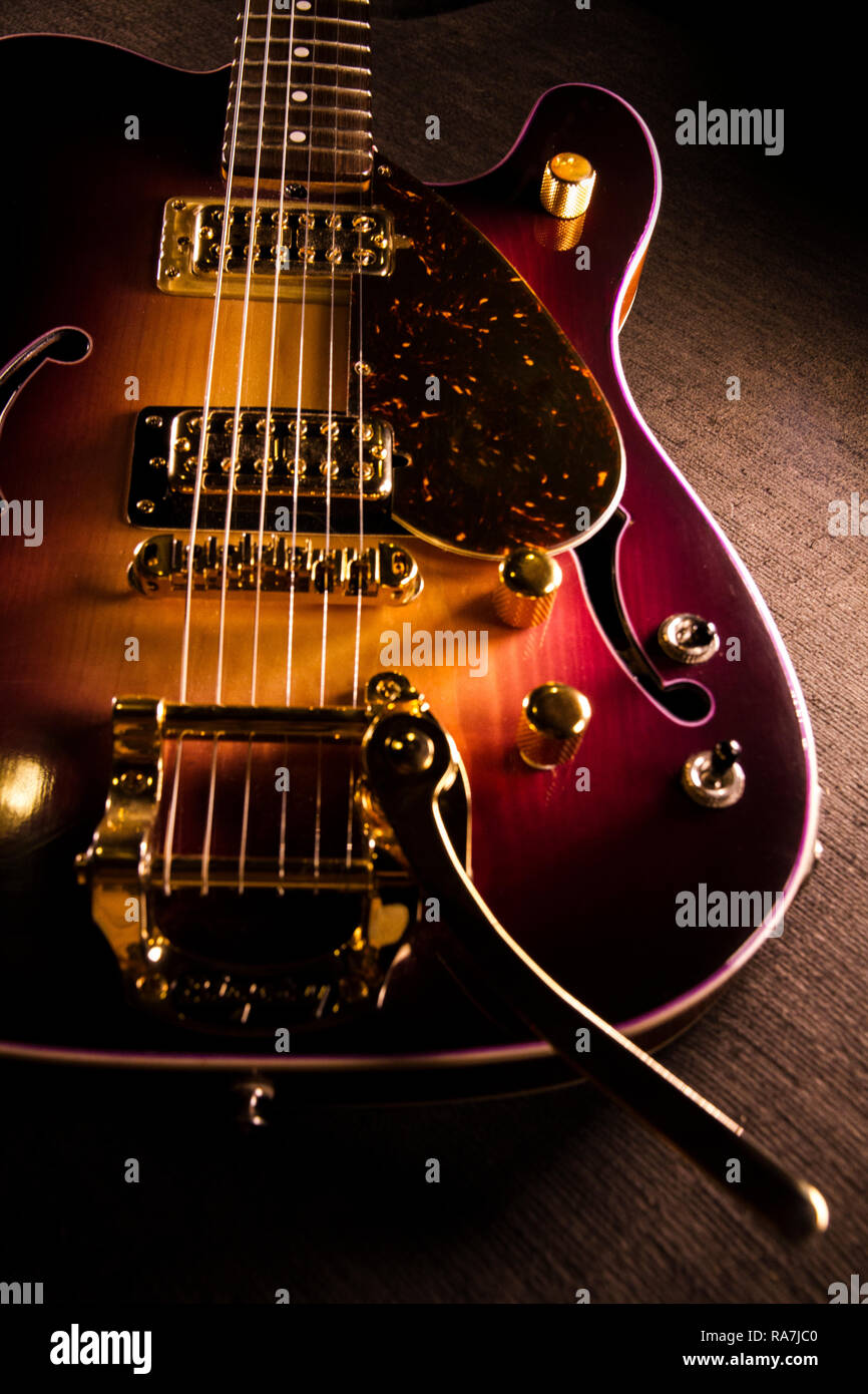 Closeup of sunburst electric guitar with brass mechanics and bright ...