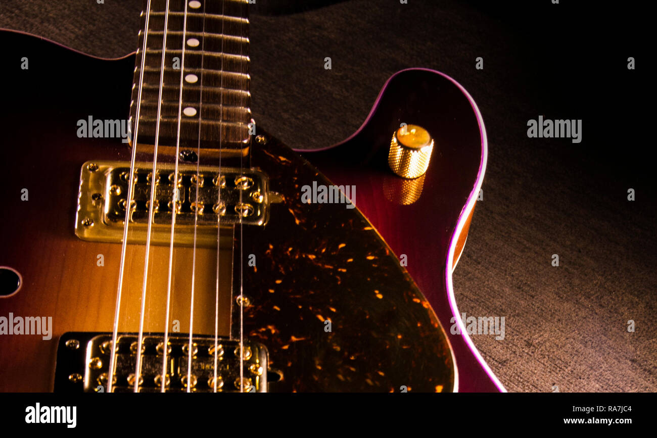 Closeup of sunburst electric guitar with brass mechanics and bright ...