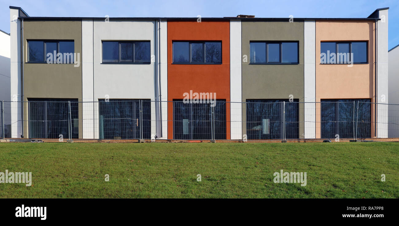 Modern standard no name houses buildings construction on grassy hill ...