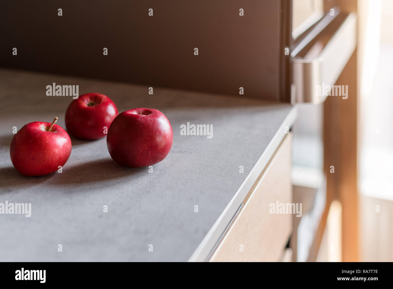 Kitchen table with red apples. Modern kitchen interior, close up Stock ...